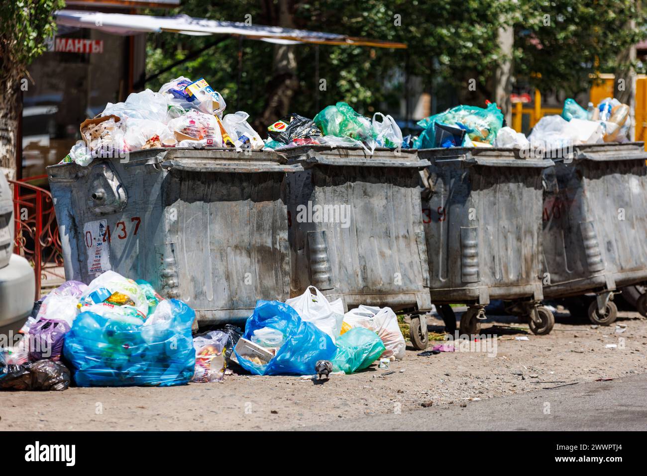 overfilled public trash bins at summer day in Bishkek, Kyrgyzstan Stock ...