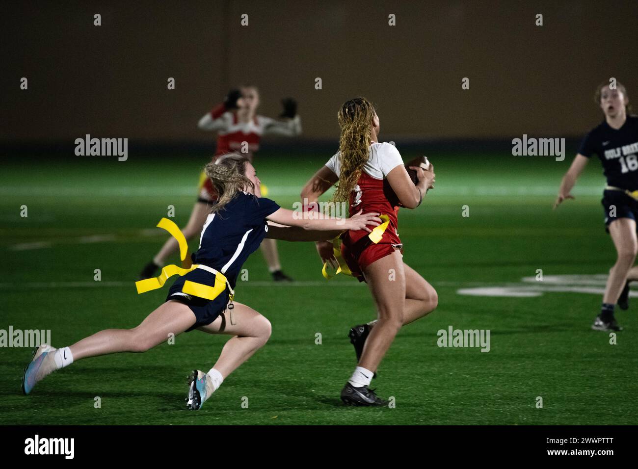 Local athletes play flag football during the Girl's Flag Football ...