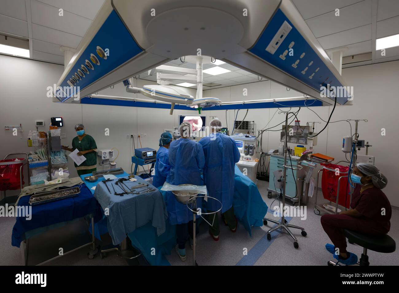 Surgeons and technicians conduct laparoscopic surgery inside a newly ...