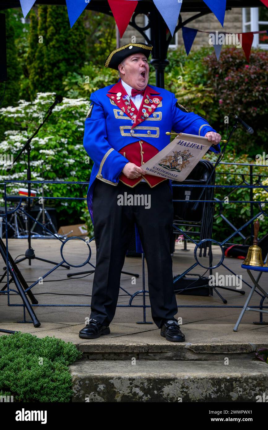 Male town crier (colourful blue red crier's clothes) proclaiming ...