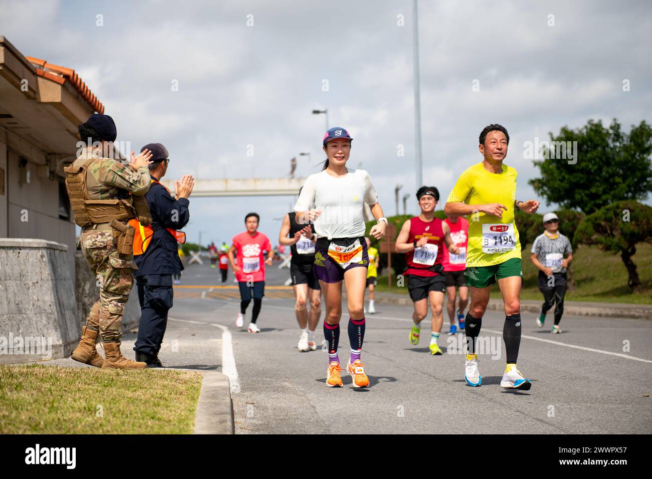 Runners exit through gate 5 during the Okinawa Marathon at Kadena Air ...