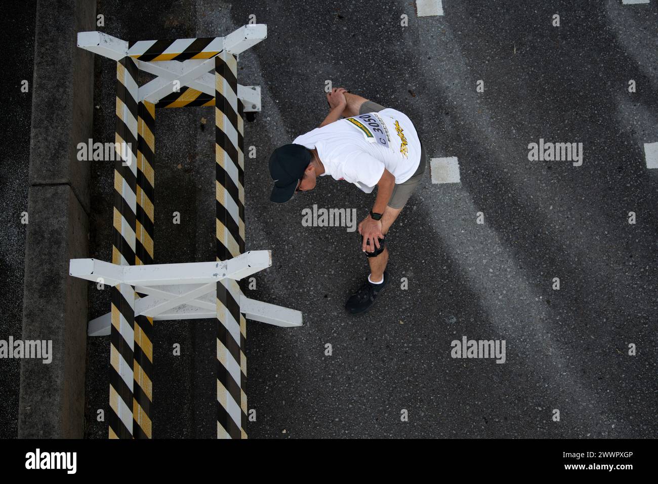 A runner stops to stretch during the Okinawa Marathon at Kadena Air ...