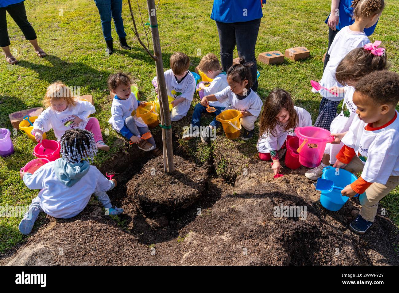 Pre-schoolers from the Child Development Center plant a tree during ...