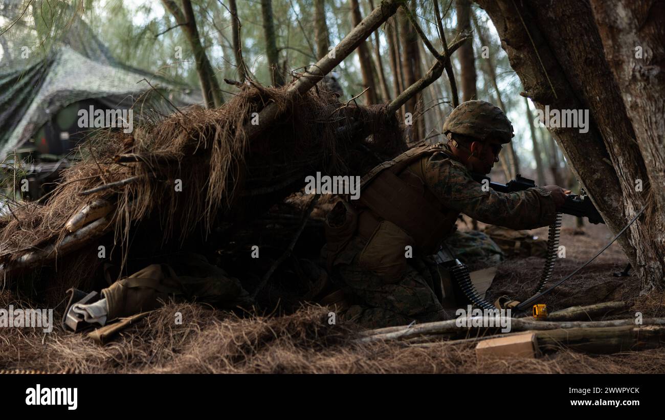 U.S. Marine Corps Sgt. Lukas Ibarra loads an M240 machine gun with ...