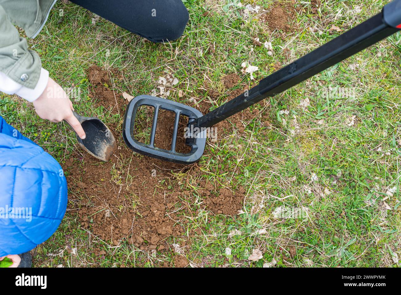 The kid treasure hunters metal detecting and digging the ground Stock ...