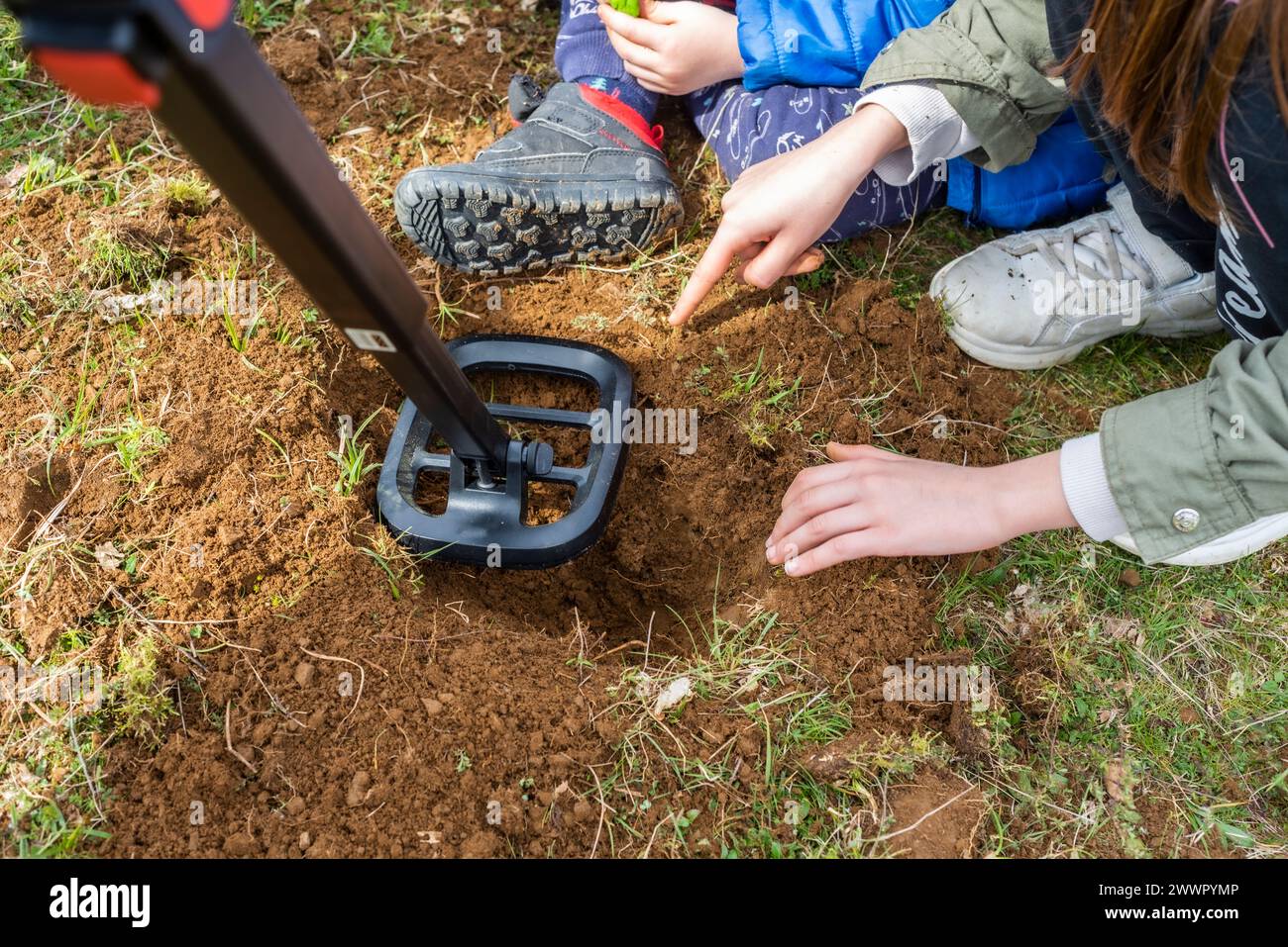 The kid treasure hunters metal detecting and digging the ground Stock ...