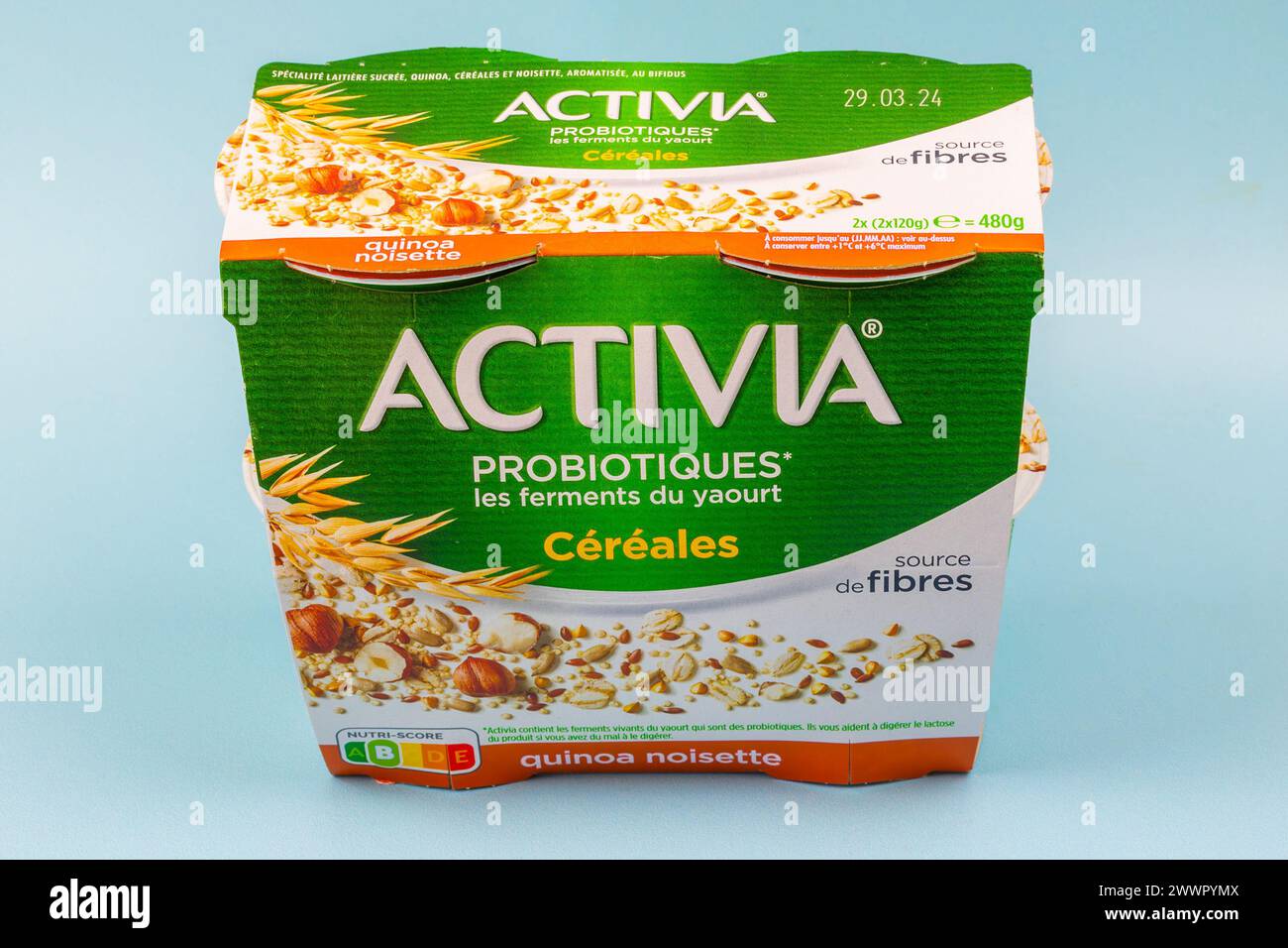 pack of 4 Activia brand cereal yogurts isolated on a blue background ...