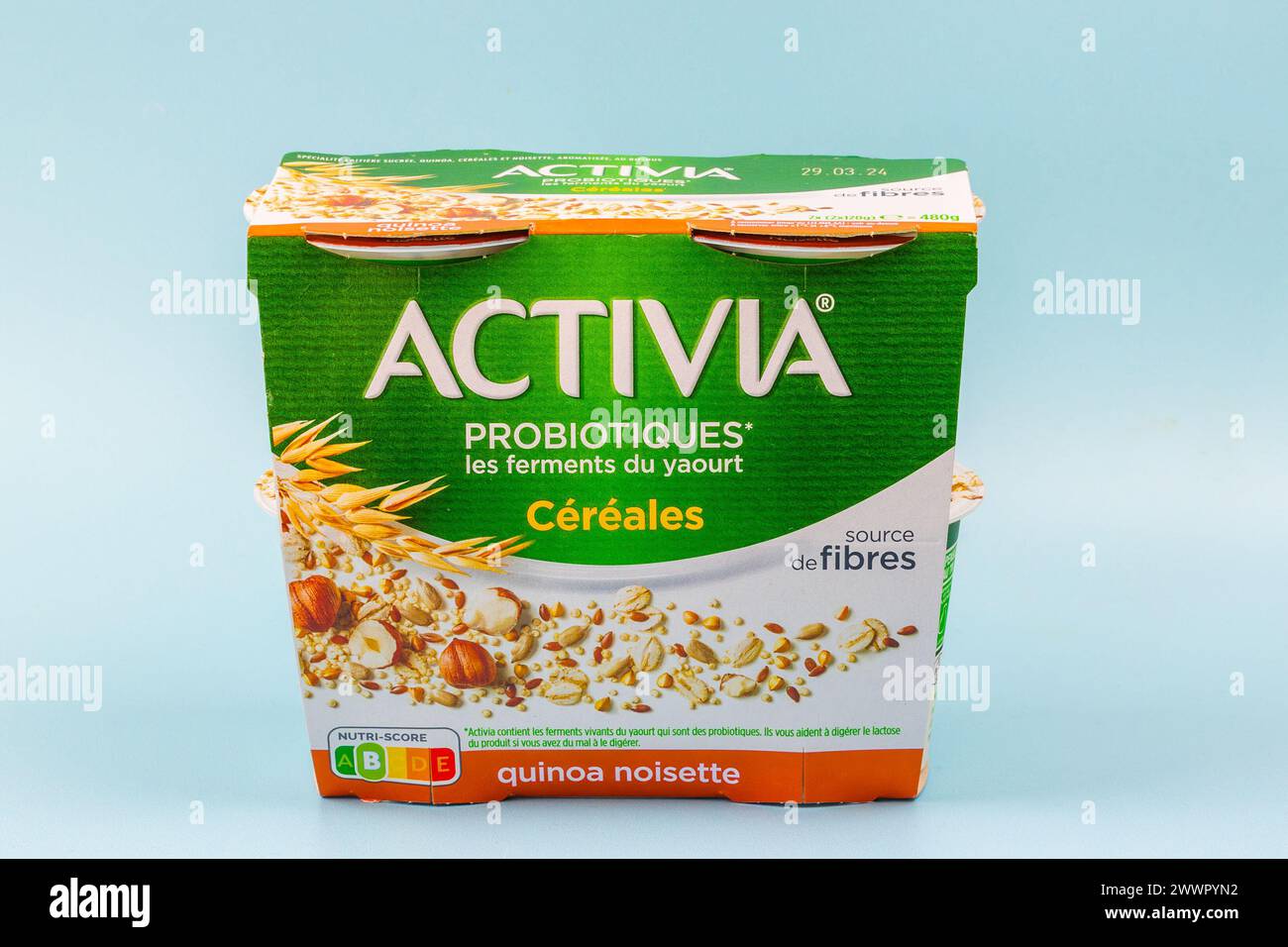 pack of 4 Activia brand cereal yogurts isolated on a blue background ...