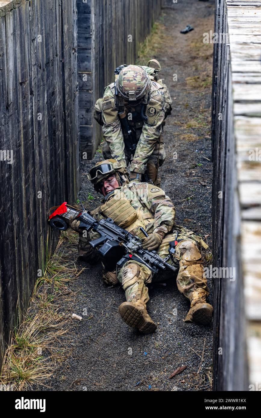 A U.S. Soldier attached to 3rd squadron, 2nd Cavalry Regiment, drags a ...