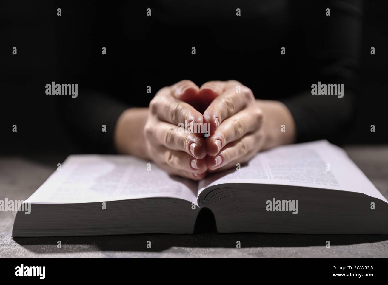Religion. Christian woman praying over Bible at table, closeup Stock ...