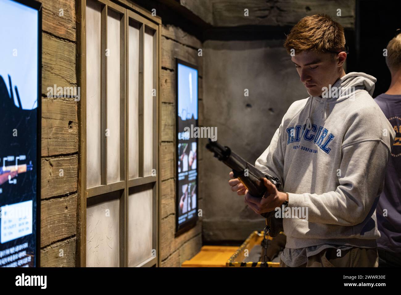 U.S. Marine Corps Lance Cpl. Hayden Sutton inspects a replica of an M1 ...