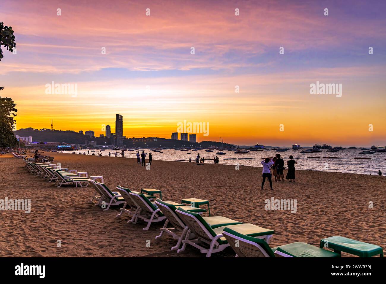 Pattaya beach landscape with sand, sun loungers, buildings, people and ...