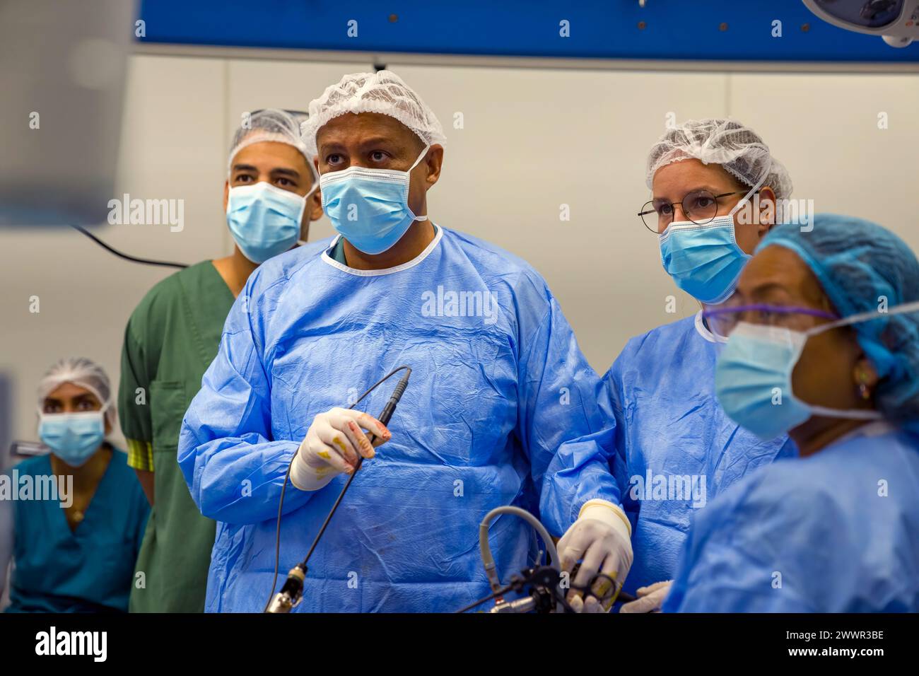 Surgeons and technicians conduct laparoscopic surgery inside a newly ...