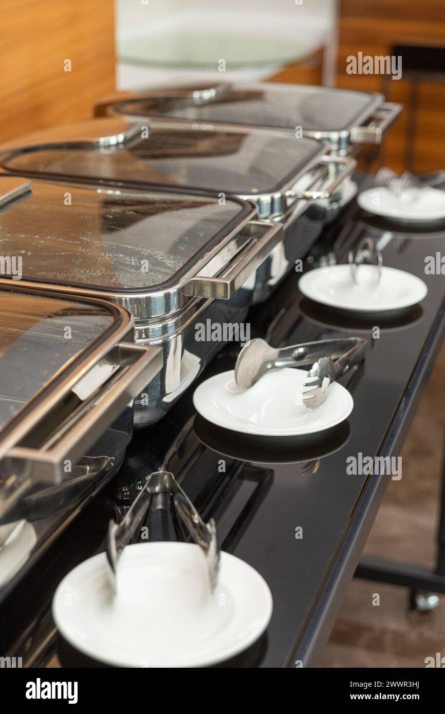 Row of closed buffet food dishes at party banquet hall. Chafing Dish ...