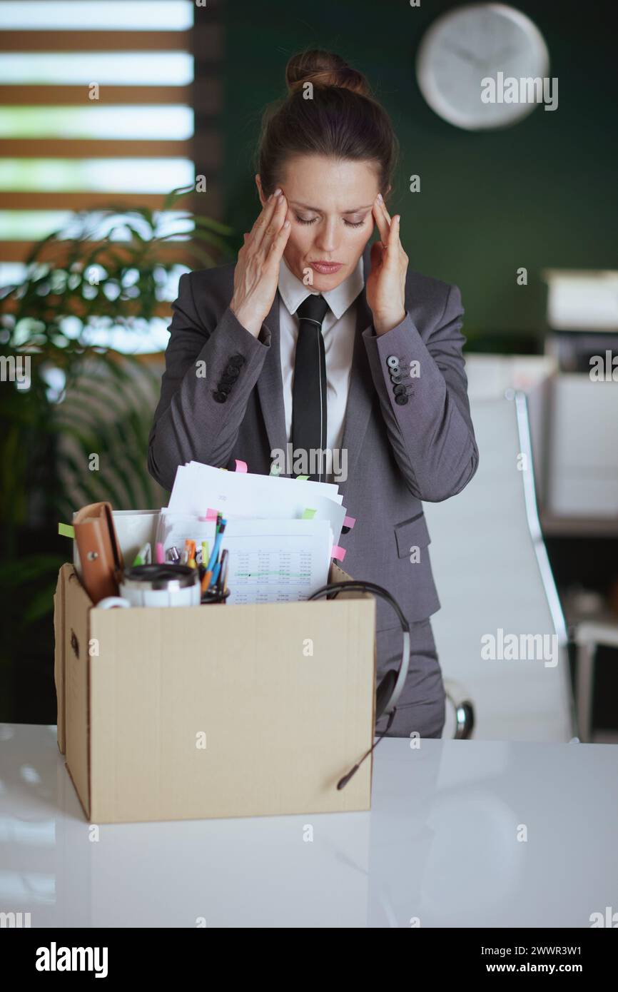 New job. concerned modern female employee in modern green office in ...