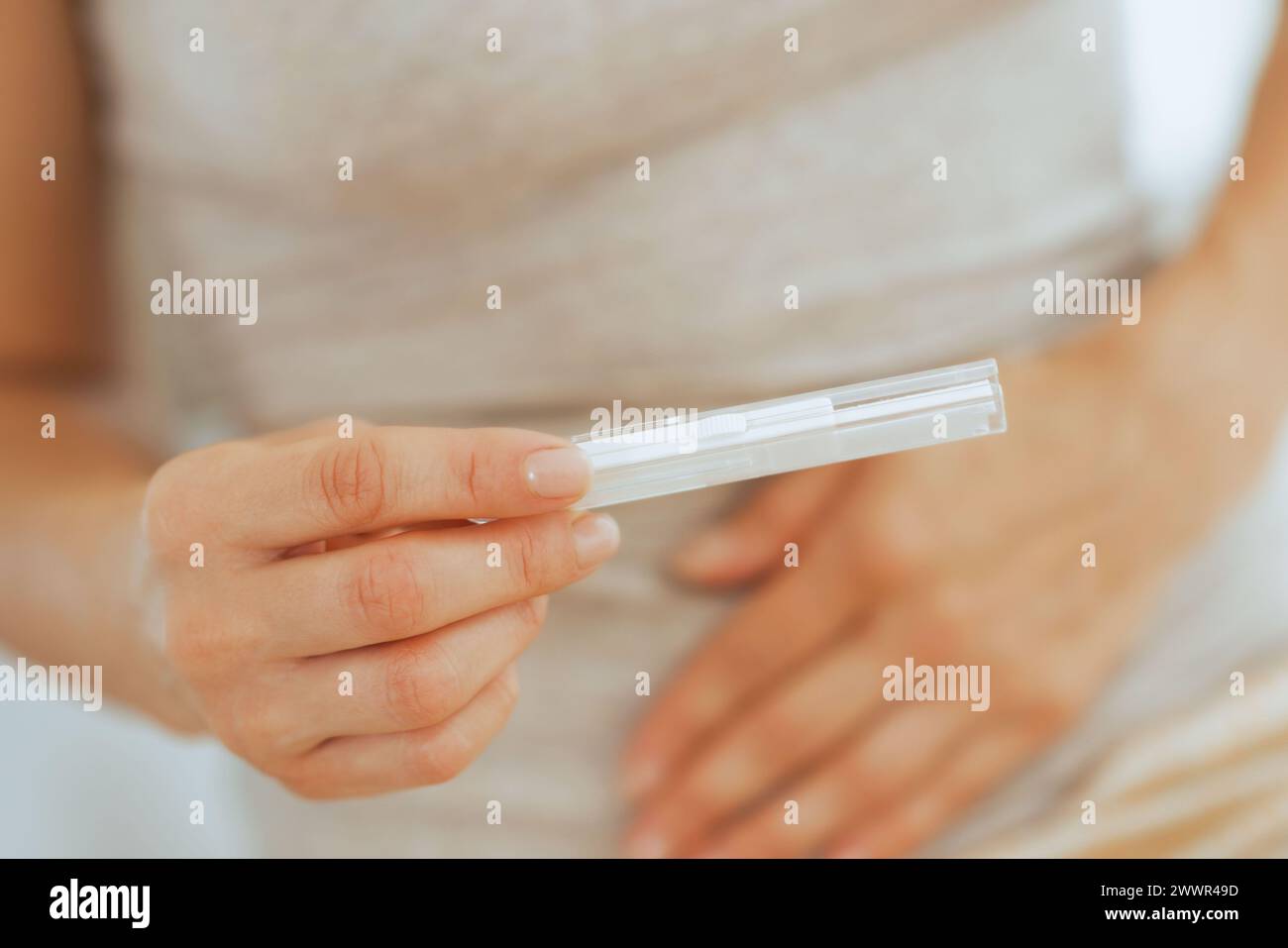Closeup on young woman holding pregnancy test Stock Photo - Alamy