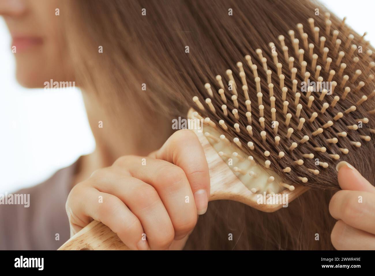 Closeup on young woman combing hair Stock Photo - Alamy