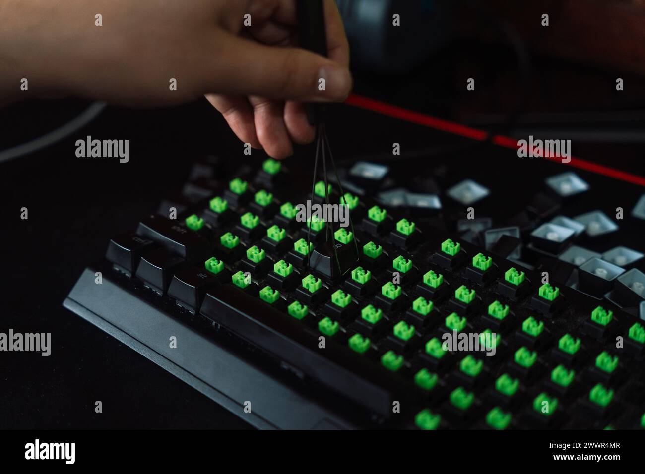 Cleaning and disassembling the keyboard. Removing keycaps using a cap ...