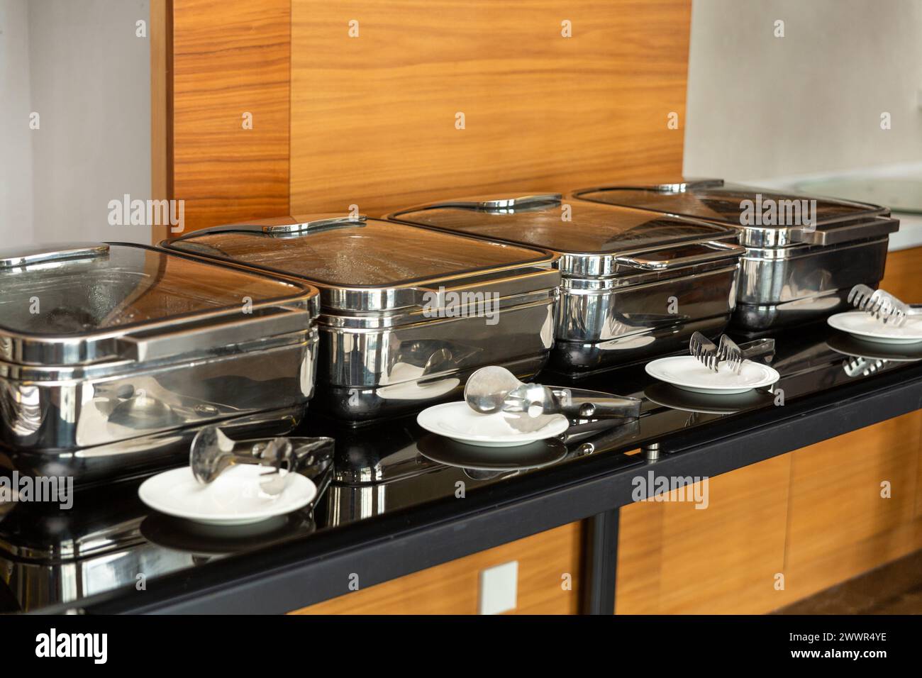 Row of closed chafing dishes at party banquet hall. Marmites ready for ...