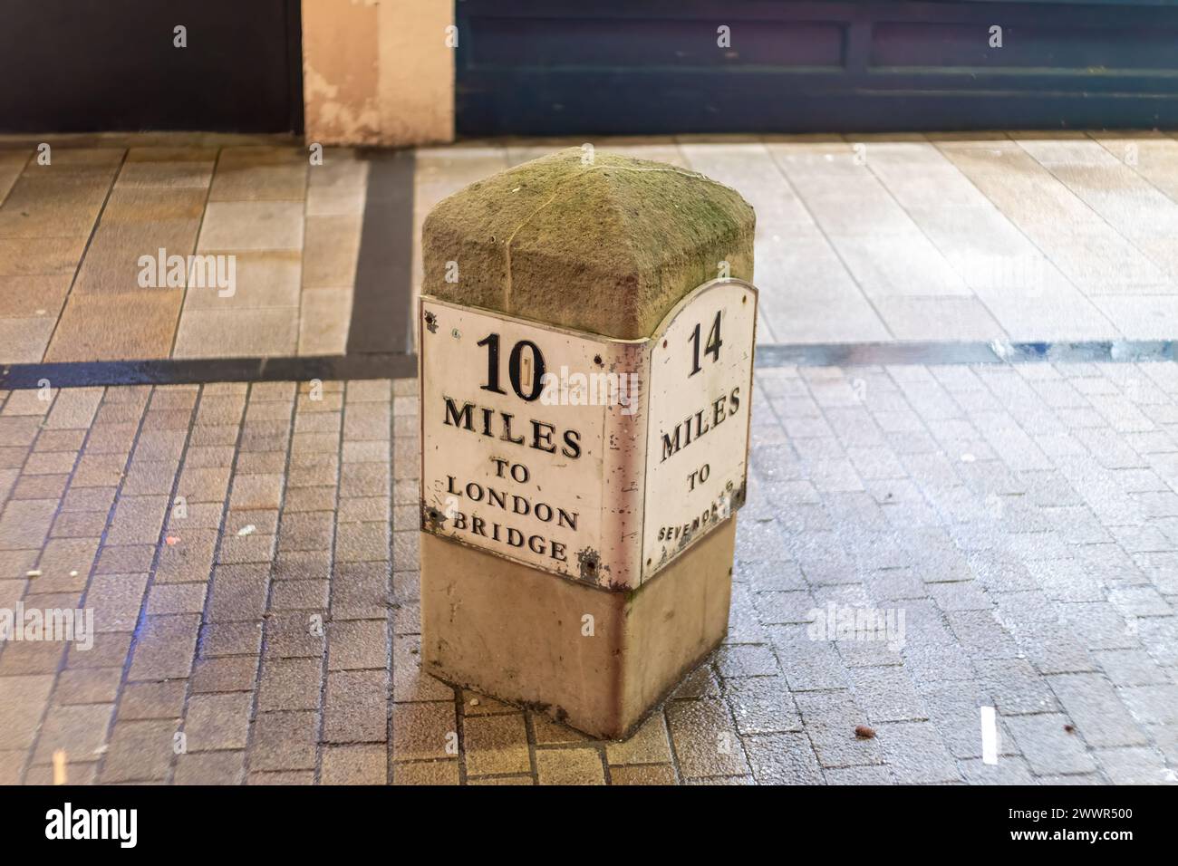 Vintage milestone indicating distance to London Bridge on a city street ...