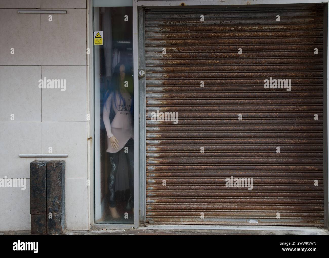 Closed shops in high street in Blackpool , rusty shutter down, display ...