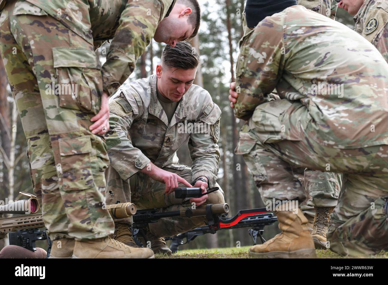 U.S. Army Staff Sgt. Jordon Behr, center, assigned to 4th Squadron, 2nd ...