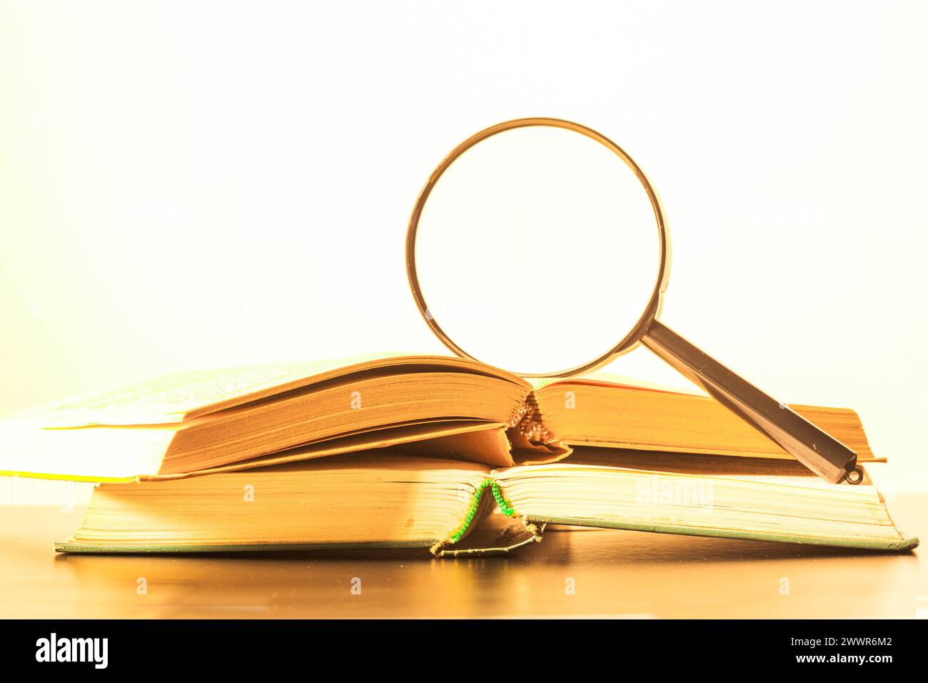 books and magnifying glass Stock Photo - Alamy