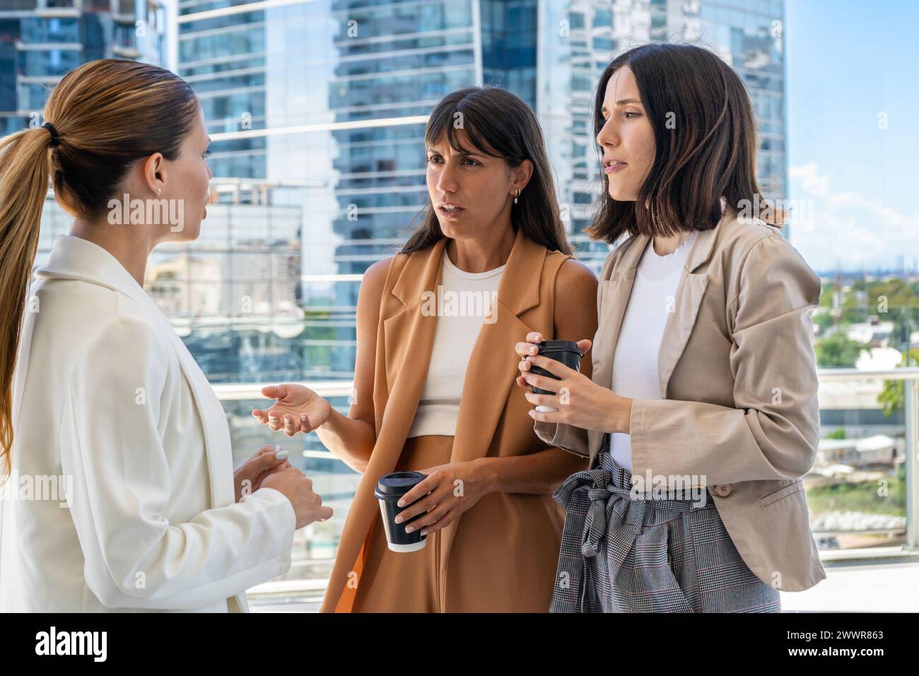 The female boss is informing her two employees that they need to focus ...