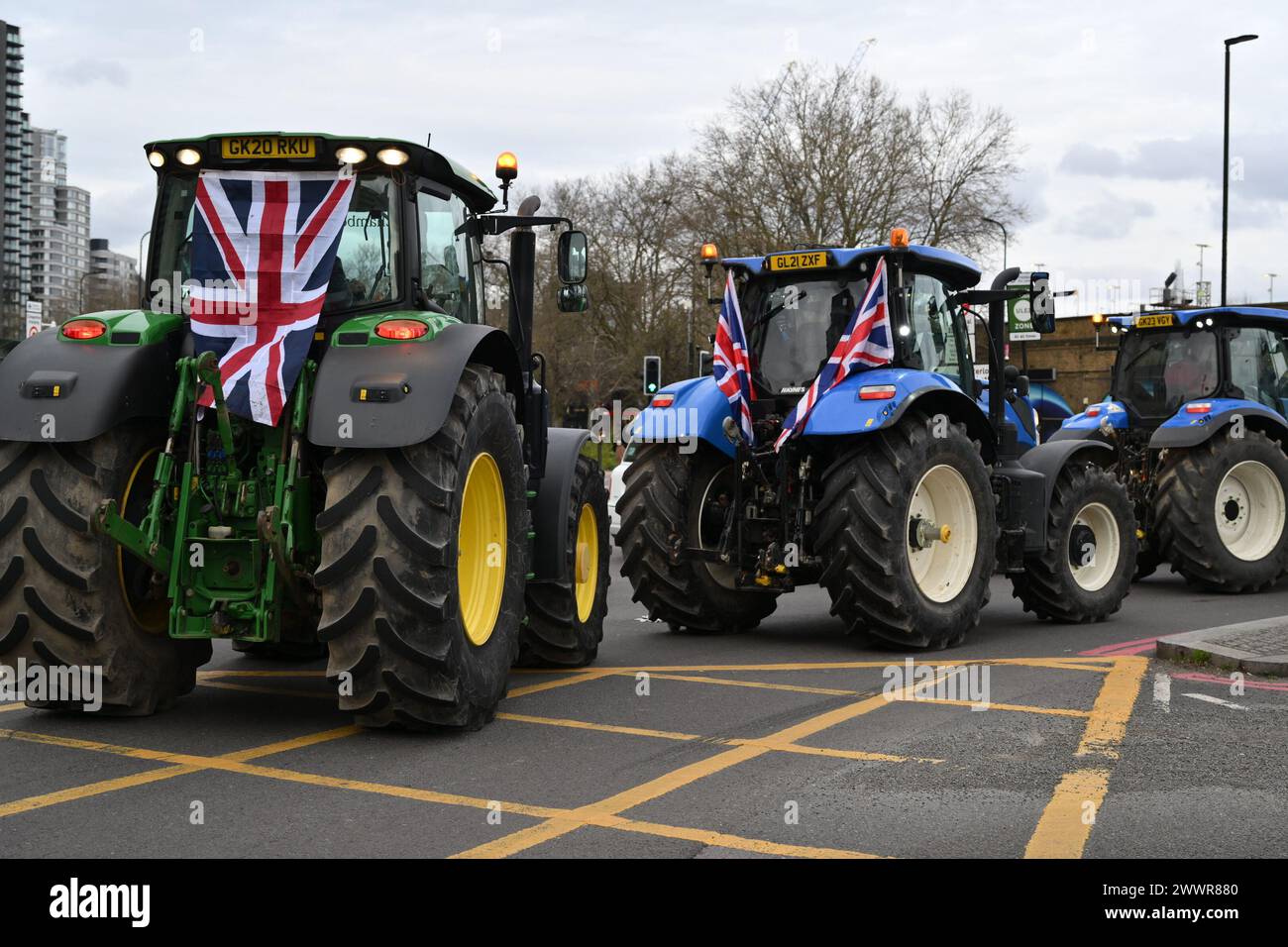 London, England, UK. 25th Mar, 2024. Farmers bring their tractors into ...