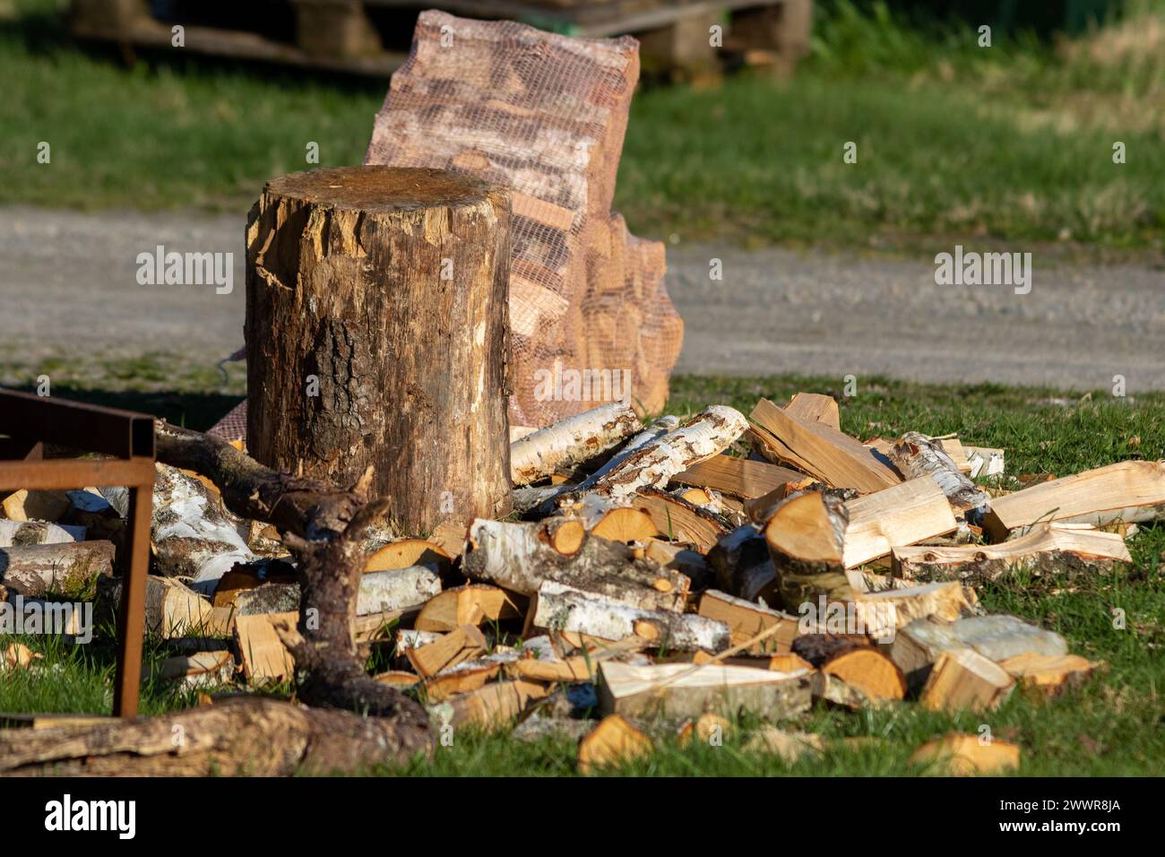 Chopped fire wood laying on ground and in a net sack Stock Photo - Alamy