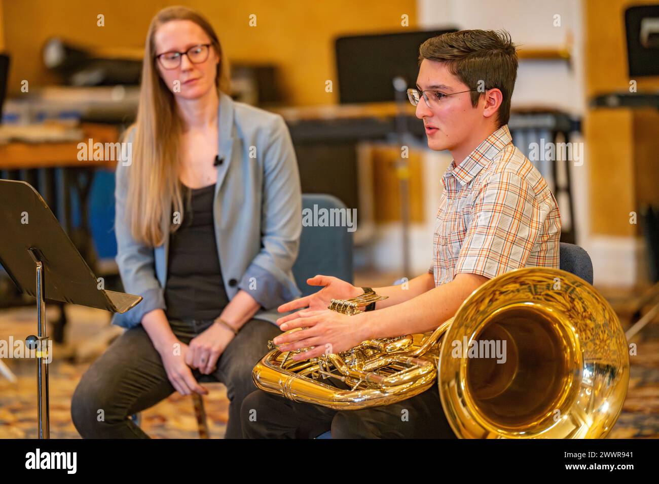 A student prepares to play the tuba next to Carol Jantsch, who's ...