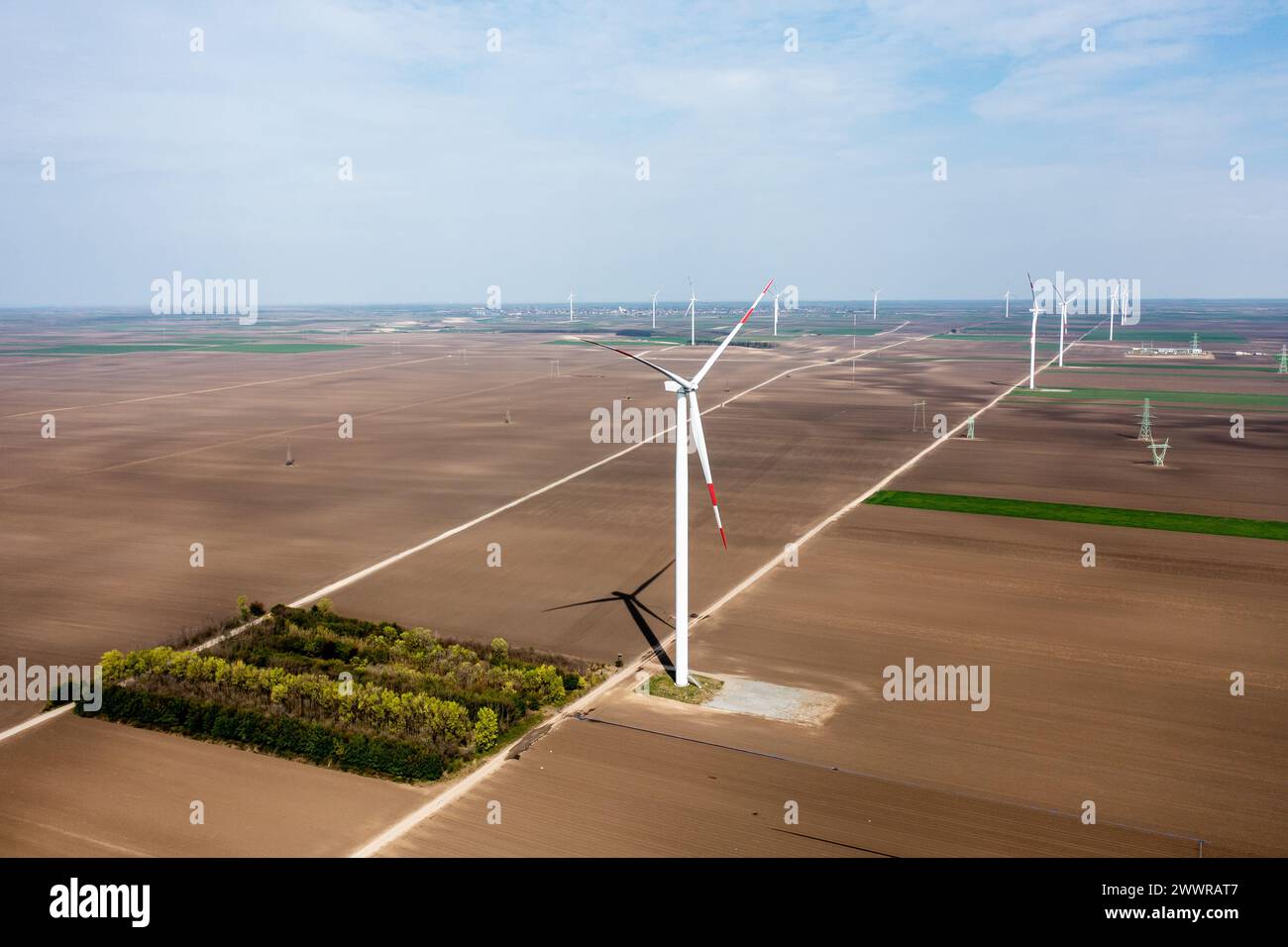 Row upon row of towering wind turbines dominate the landscape ...