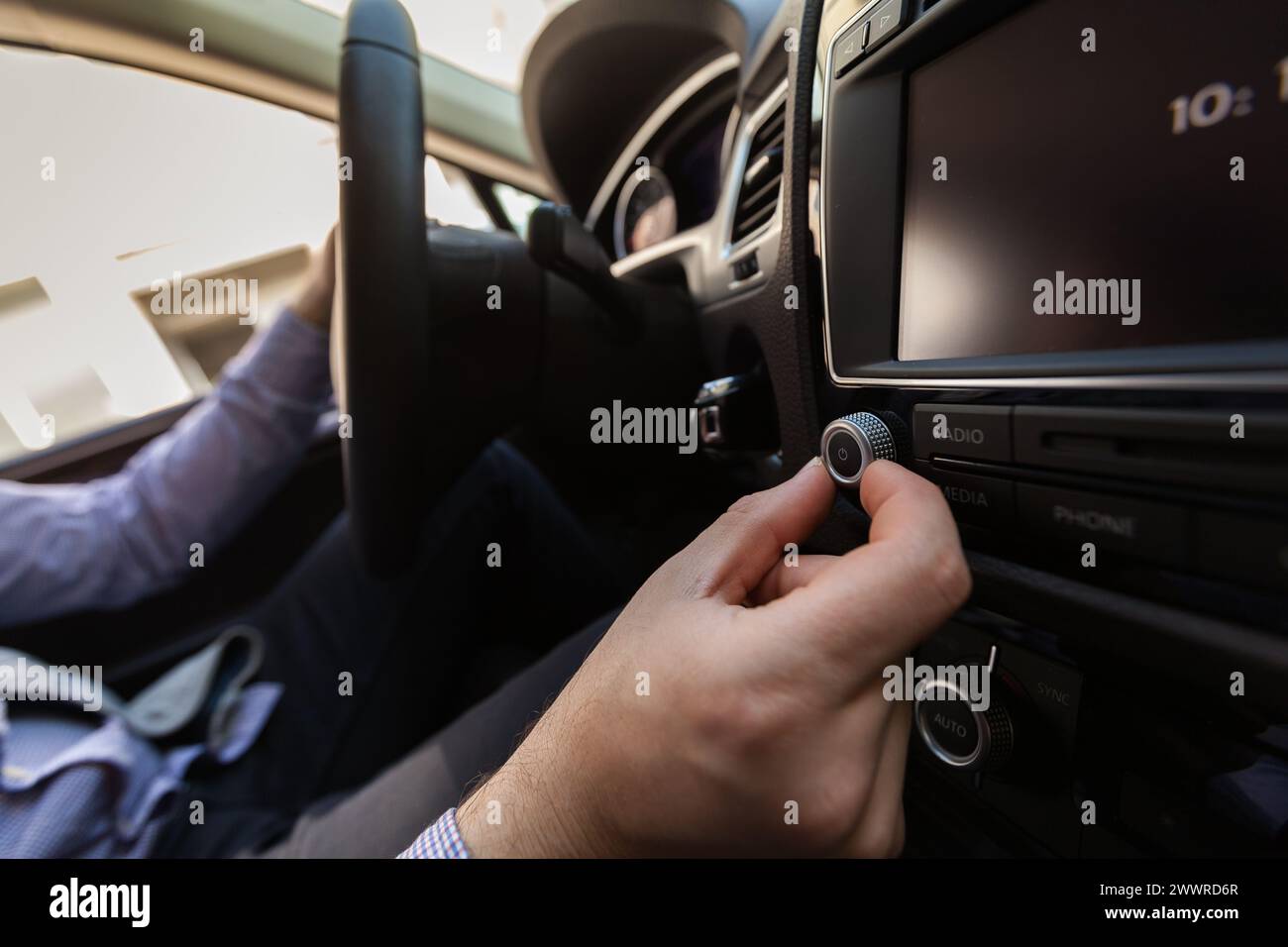 Hand Pushing the power button to turn on the car stereo system Stock ...