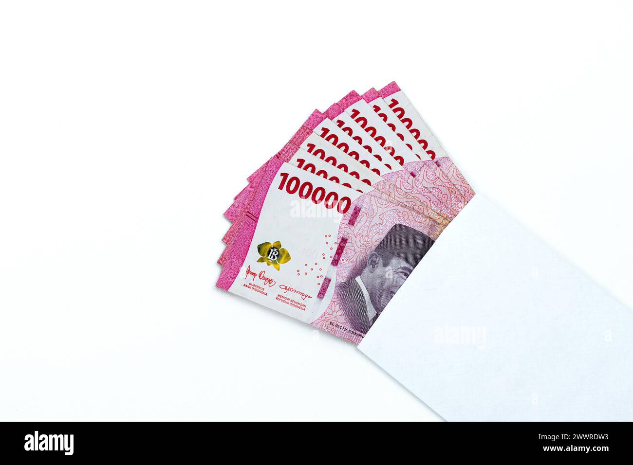 Indonesian rupiah currency. White envelope containing IDR 100,000 in ...