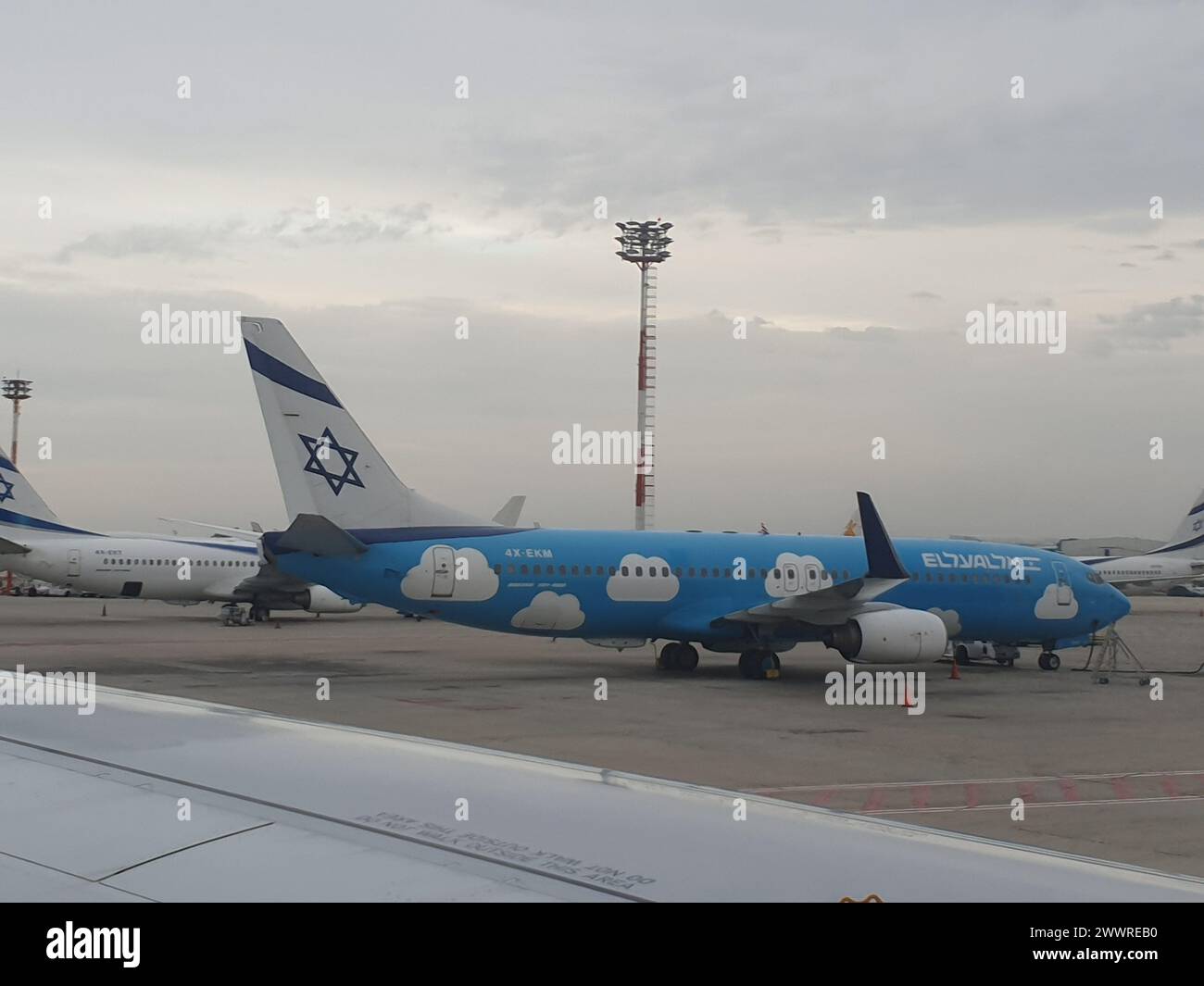 Airplane with blue livery and cloud design parked at airport Stock ...