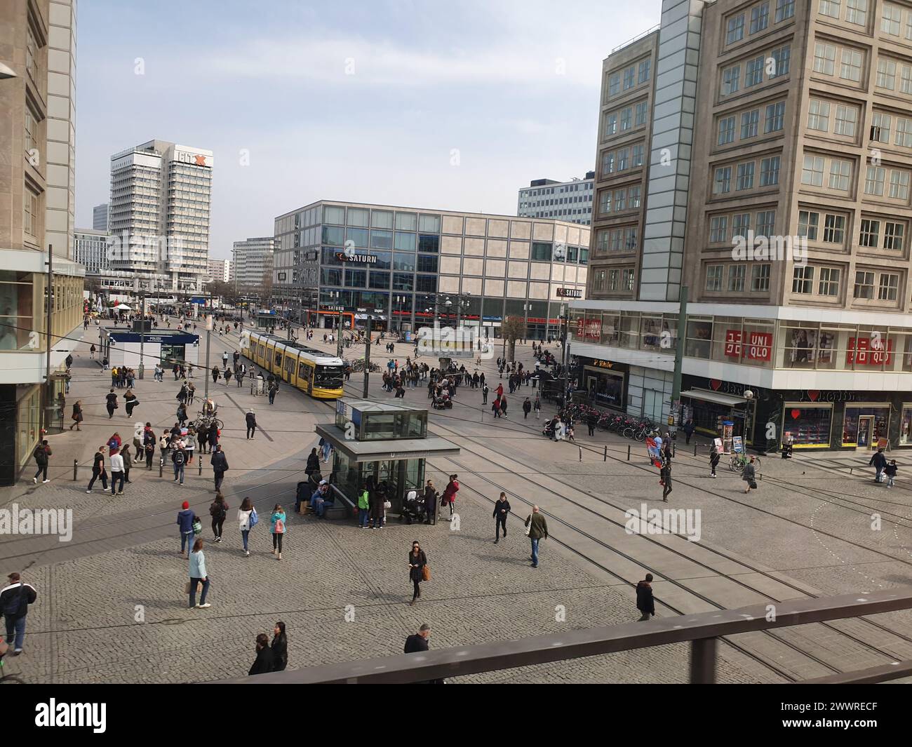 A crowded city street with a massive building and many people Stock ...