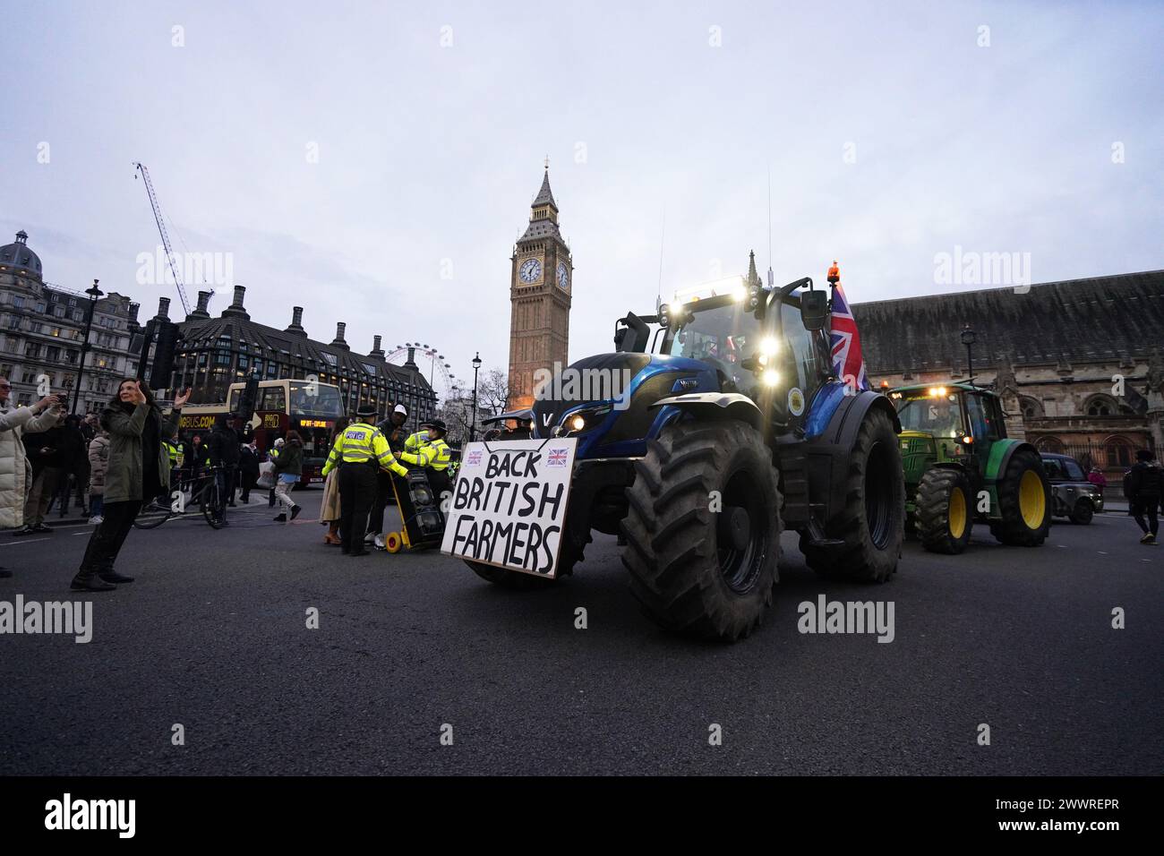 Farmers take part in a tractor "go-slow" through Parliament Square ...