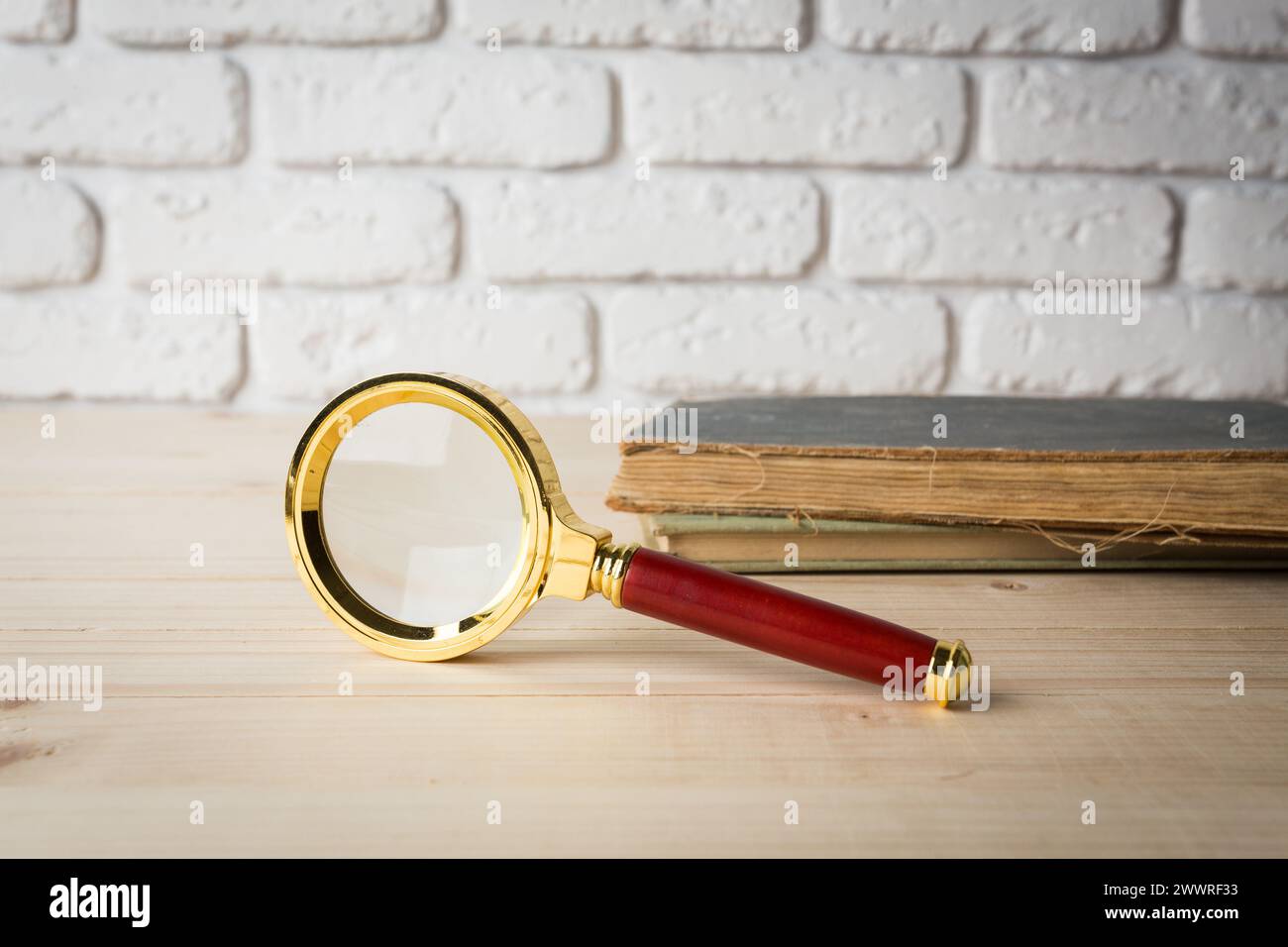 Magnifying glass and book Stock Photo - Alamy