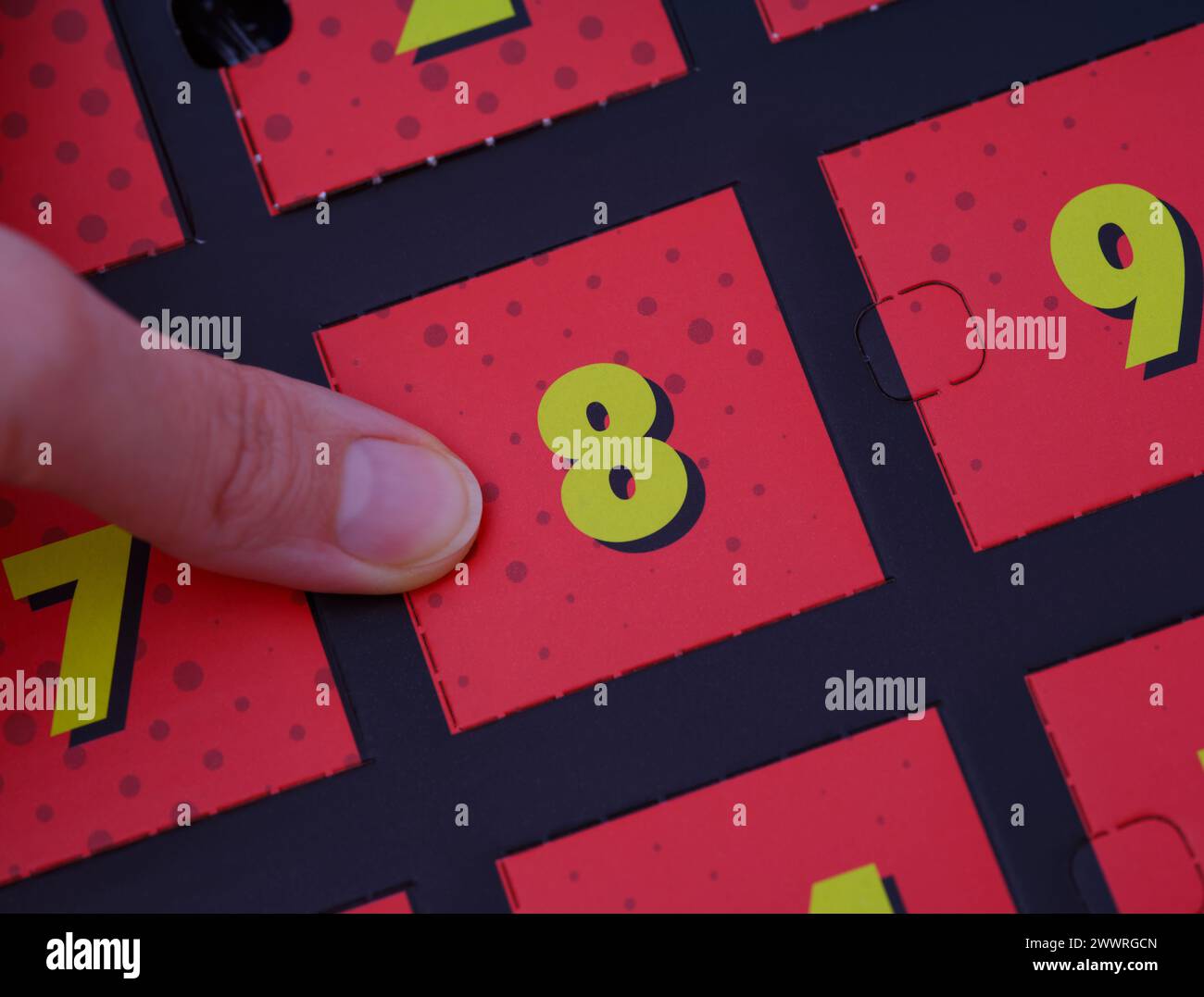 A woman hand ready to open the door with number 8 on the advent ...