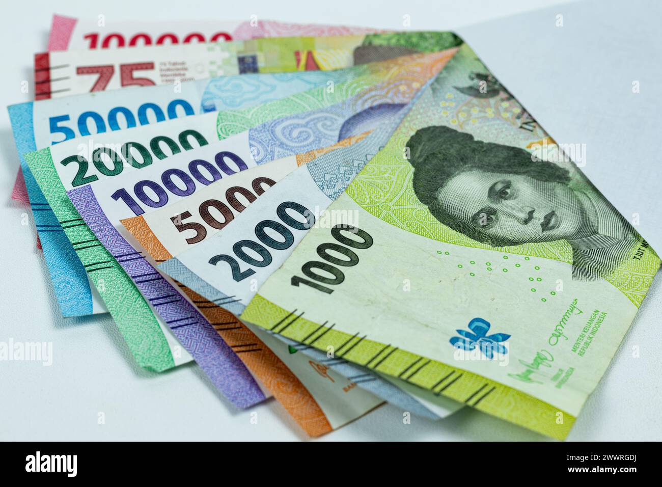 Indonesian currency. Stack of Rupiah or IDR banknotes inside white ...