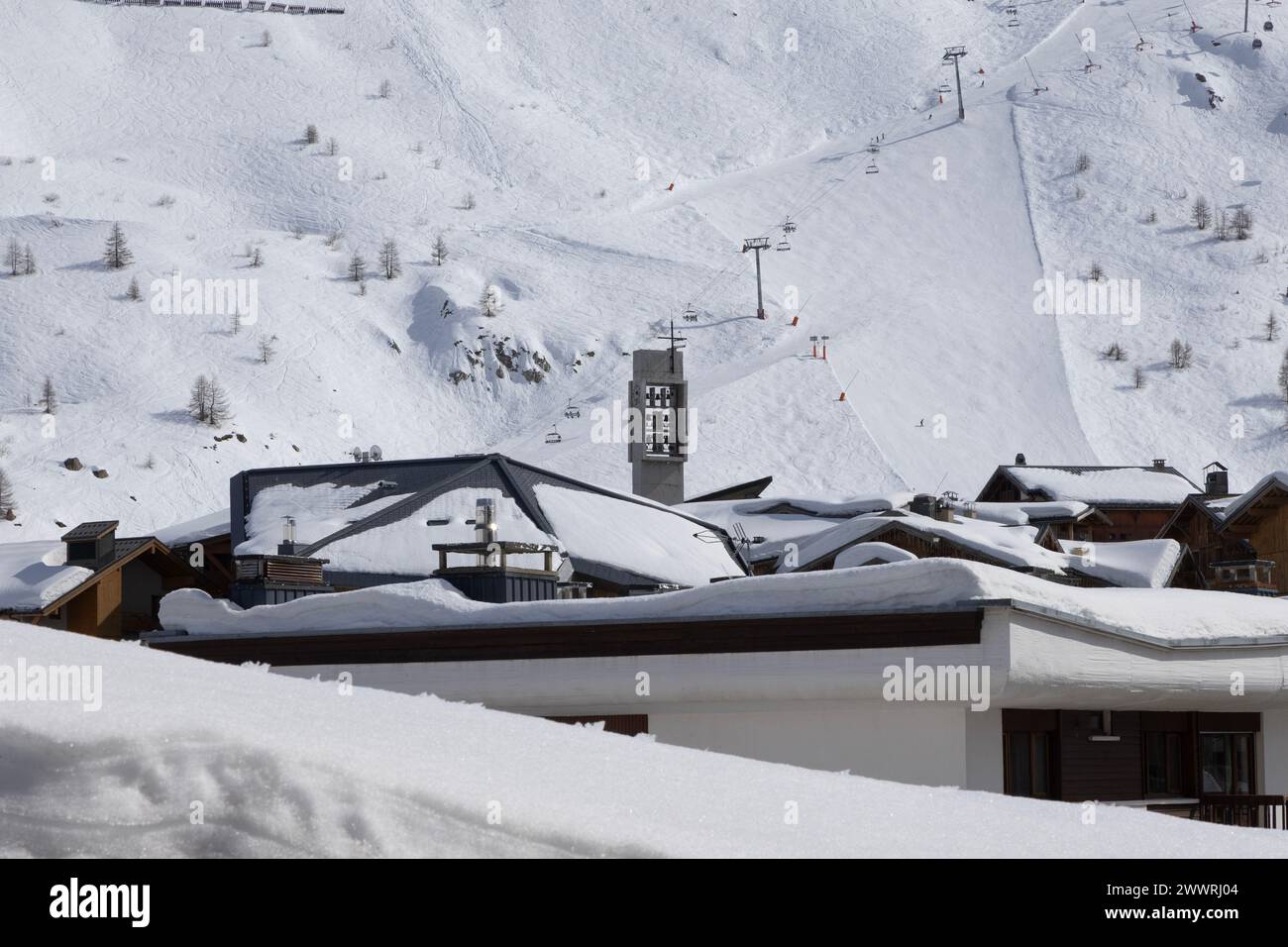The bell-tower of the modernist Roman Catholic church peeks out over ...