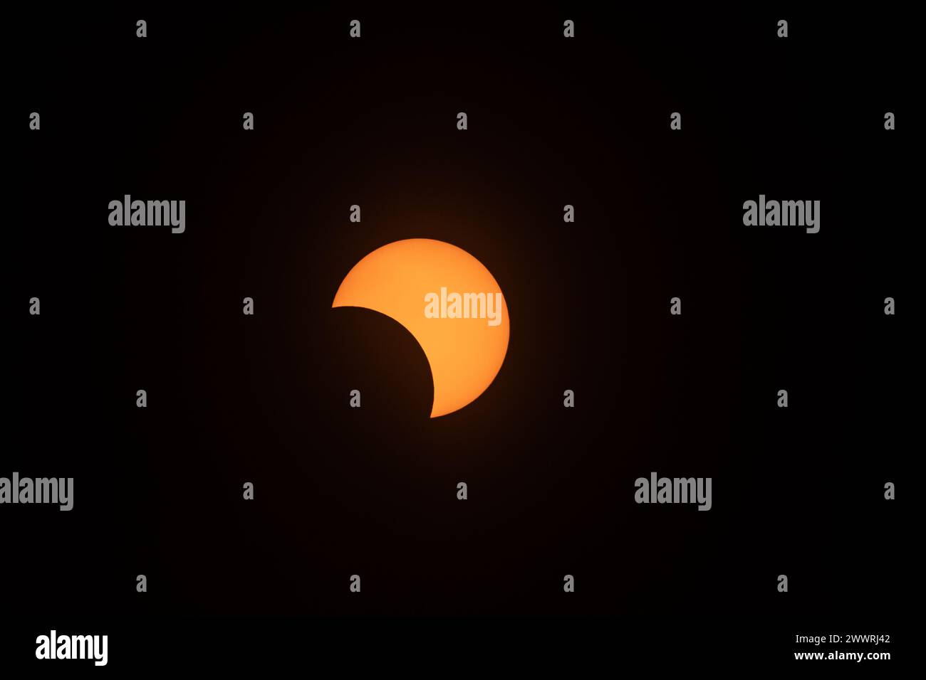 Photograph taken with a solar filter of a solar eclipse in which the ...