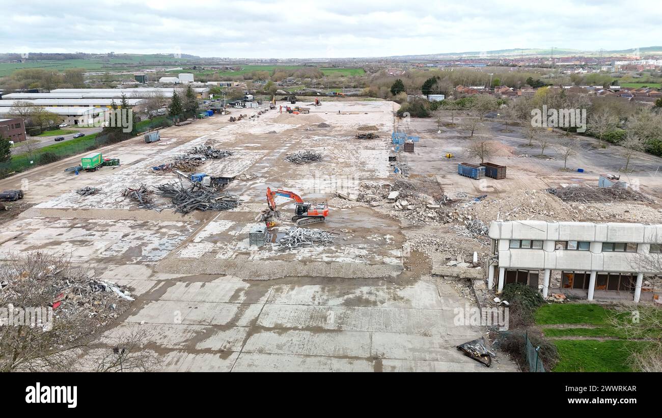 An industrial construction site with a large pile of debris and ...