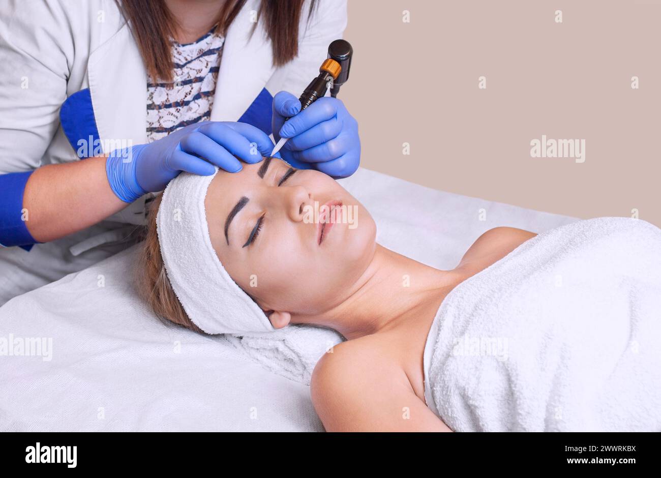 Permanent make-up for eyebrows of beautiful woman with thick brows in ...