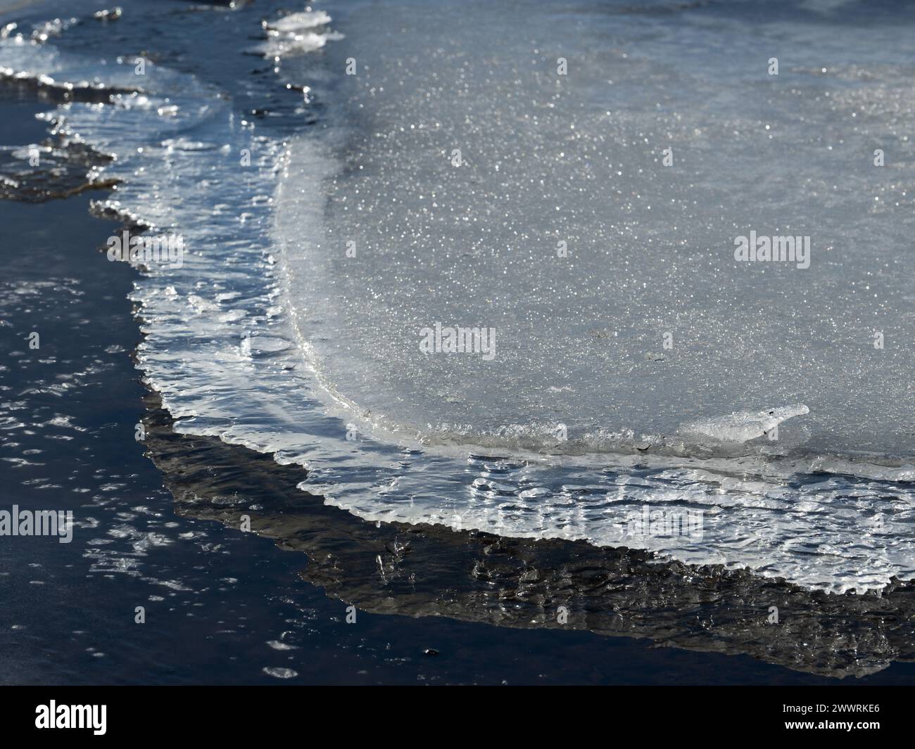Ice formations on water's edge in sunlight Stock Photo - Alamy