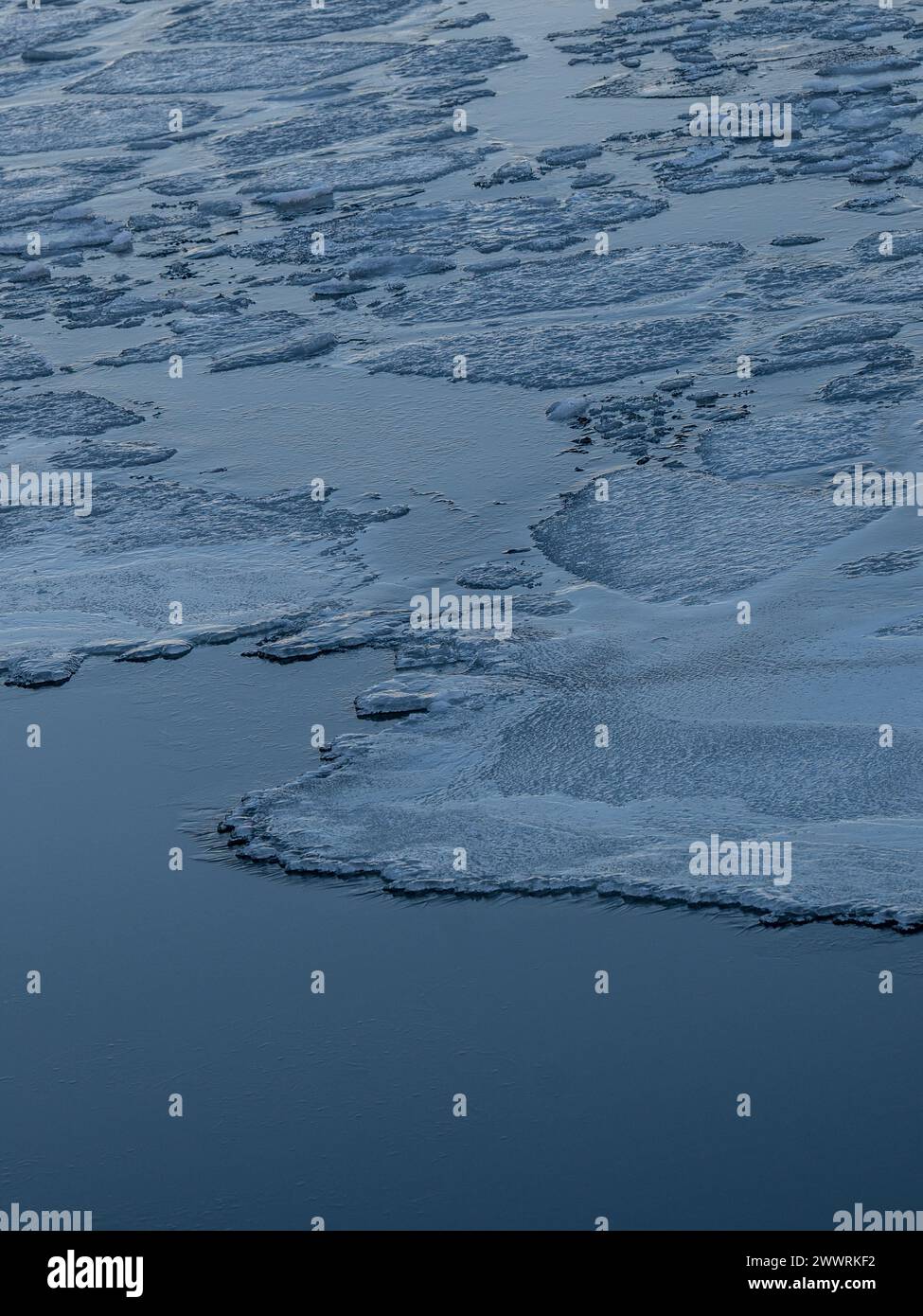Small ice formations partially frozen at the ocean's edge Stock Photo ...
