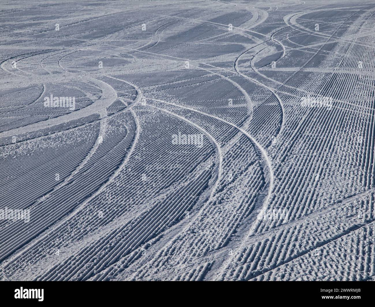Skiing background - downhill ski tracks on a slope Stock Photo - Alamy