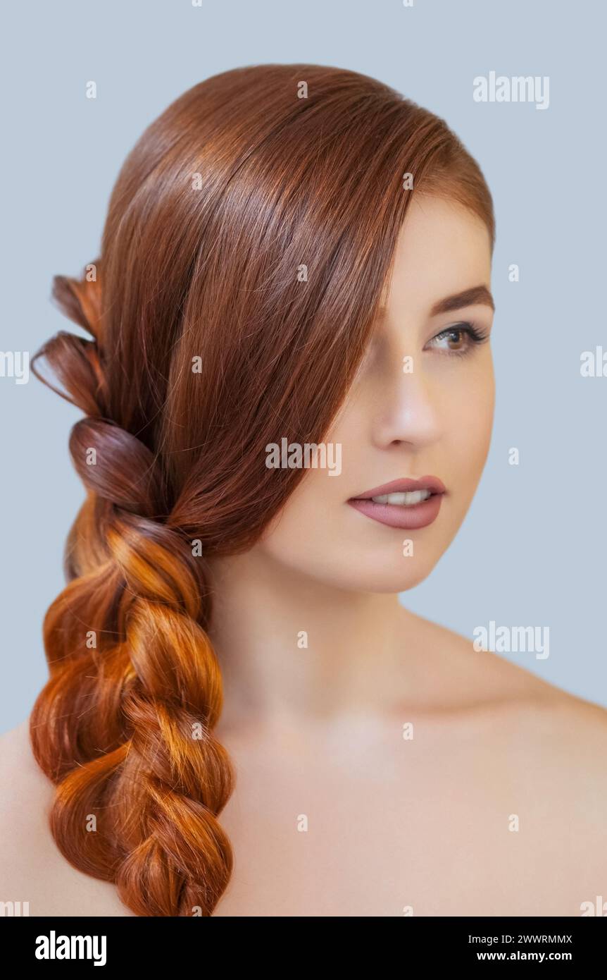 Beautiful girl with long red hair, braided with a French braid, in a ...