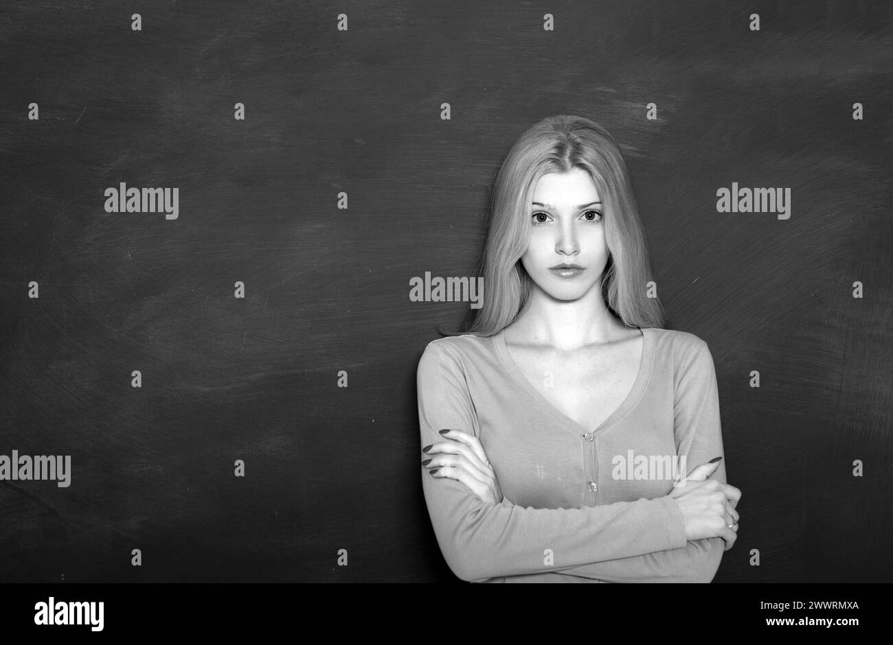 School teacher in class on blackboard background. Professional portrait ...