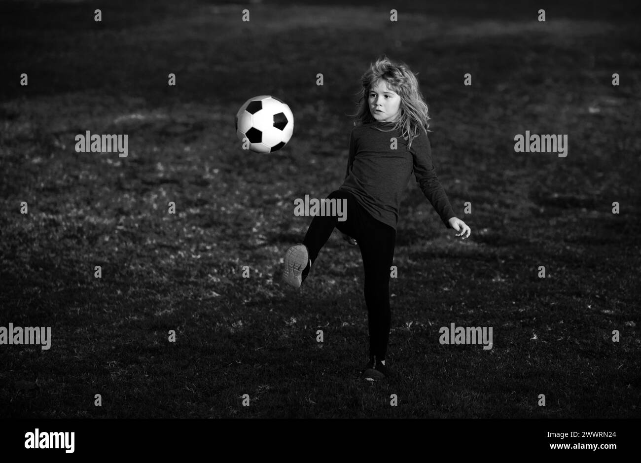 Young soccer player in sportswear with soccer ball. Cheerful little boy ...